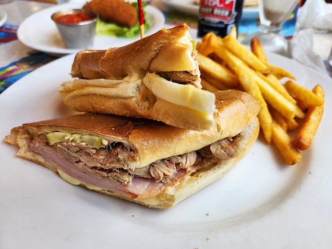 The Cuban sandwich arrives like a diplomatic mission between bread nations &ndash; ham, pork, and pickles negotiating perfect harmony on your plate.
