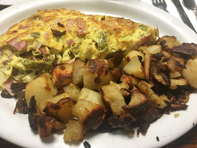 This Denver omelet with home fries isn't just breakfast&mdash;it's edible architecture, with each ingredient playing its crucial structural and flavor role to perfection.