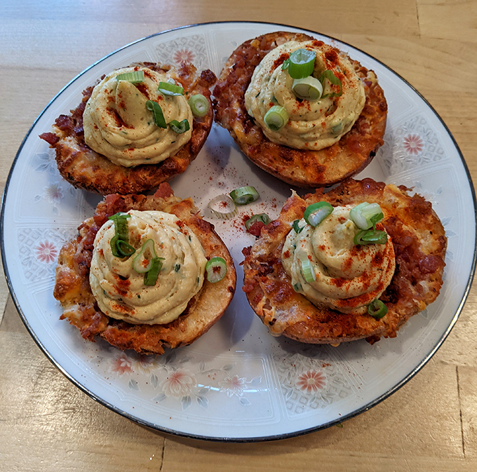 These aren't your grandmother's deviled eggs—they're deviled potato skins, wearing their creamy toppings like tiny edible berets.