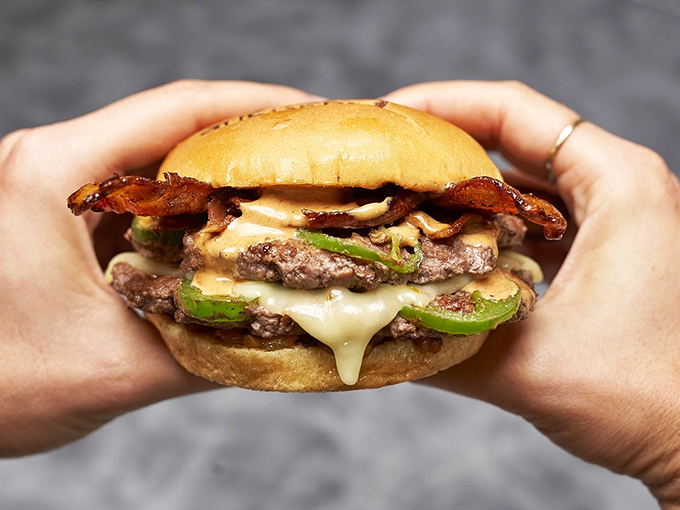 This isn't just a burger &ndash; it's architecture. Melty cheese cascades over double patties while jalape&ntilde;os and bacon add that perfect flavor counterpoint. 