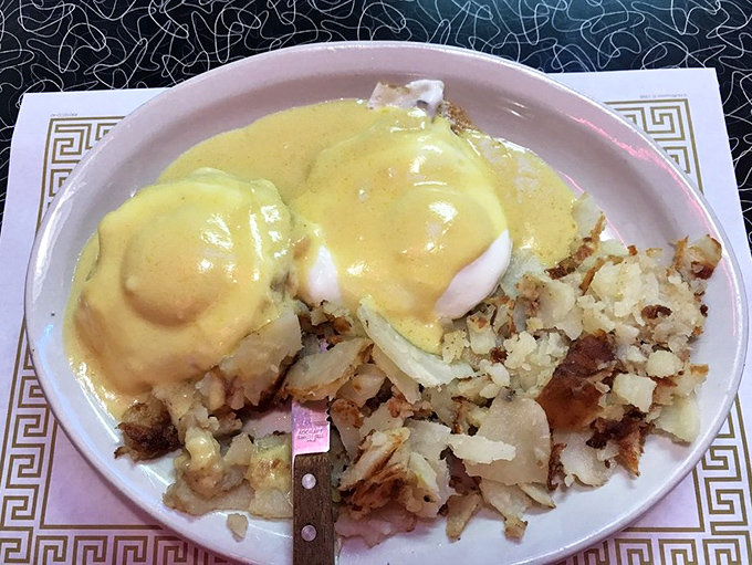 Eggs Benedict that would make the Pope jealous—perfectly poached eggs draped in hollandaise, perched atop a throne of home fries.
