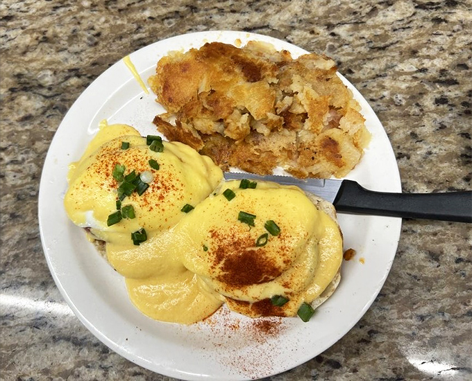 Eggs Benedict with a hollandaise sauce that defies the laws of breakfast physics &ndash; somehow both rich and light, dusted with paprika for that extra touch.