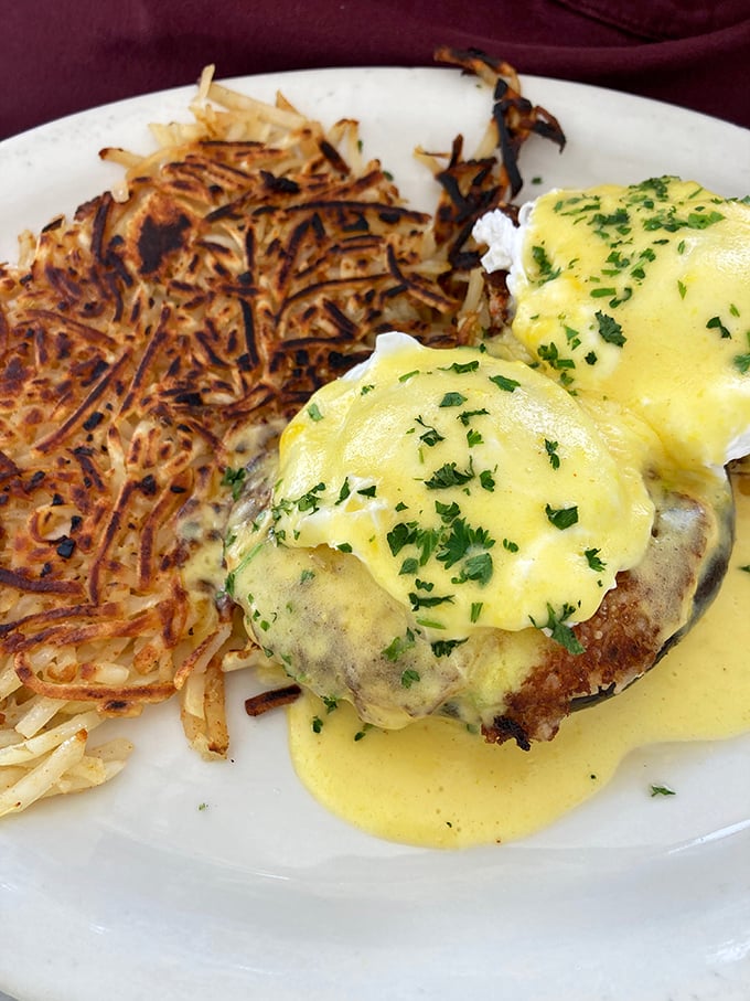 Eggs Benedict with a side of crispy hash browns&mdash;proof that perfection doesn't need reinvention, just consistent execution.