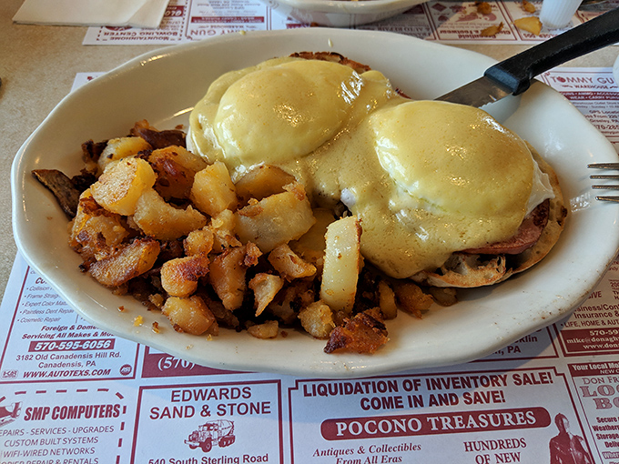 Eggs Benedict done right&mdash;hollandaise cascading over Canadian bacon and English muffins. Paired with those seasoned home fries, it's morning nirvana on a plate.