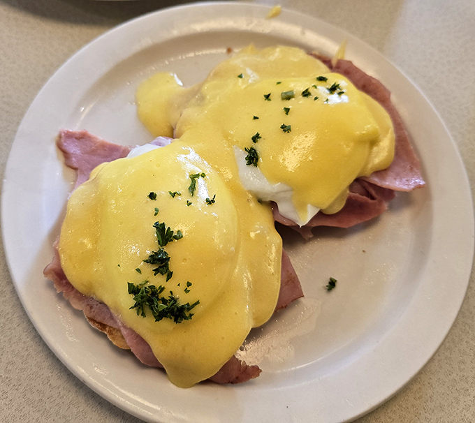 Eggs Benedict that would make a brunch snob weep with joy&mdash;perfectly poached eggs, Canadian bacon, and hollandaise sauce that's worth getting out of bed for.