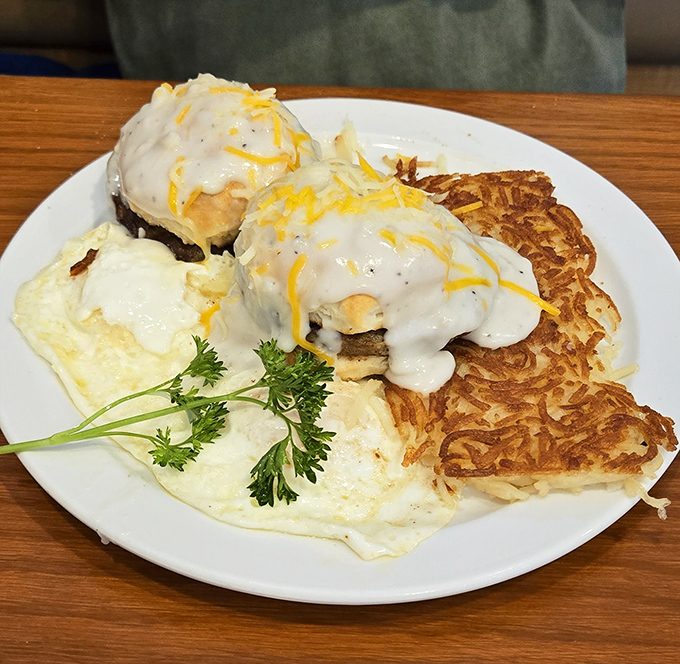 Eggs Benedict gets the royal treatment here, crowned with hollandaise and served alongside those crispy hash browns that deserve their own fan club.