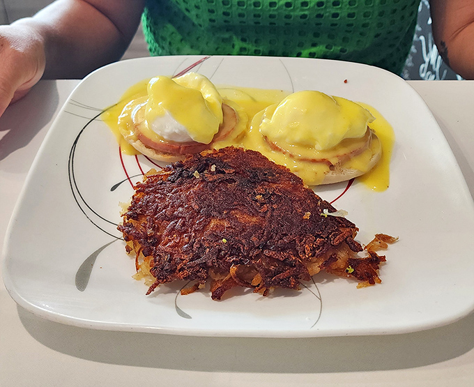 Hollandaise sauce should be considered a national treasure. These eggs benedict with their golden crowns sit majestically alongside hash browns that could make a potato farmer weep with pride.