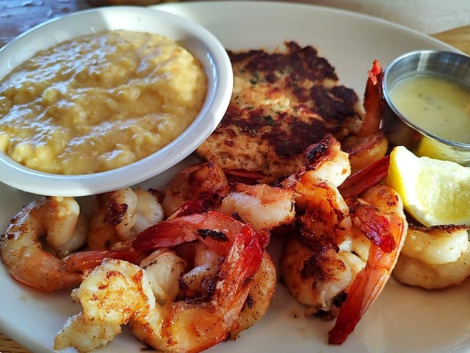 Perfectly grilled shrimp nestled beside grits that would make your grandmother both jealous and proud. The lemon wedge isn't optional &ndash; it's essential.