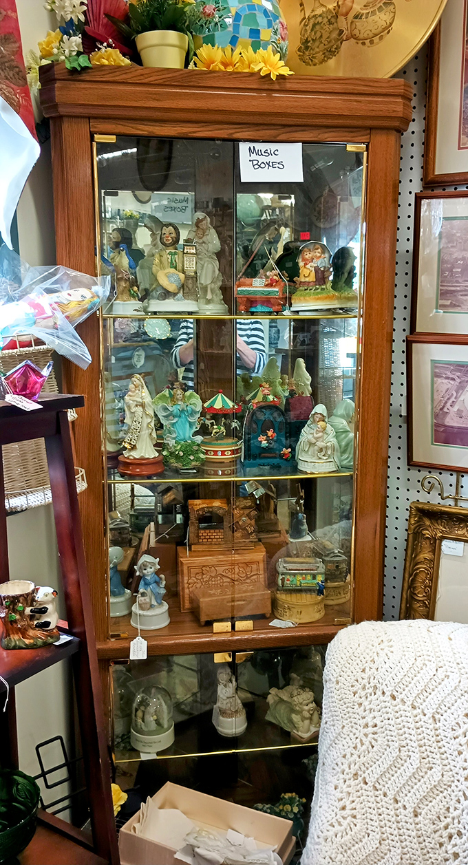 This glass cabinet of music boxes and figurines tells silent stories of bygone eras, each porcelain face frozen in a permanent expression of wonder.