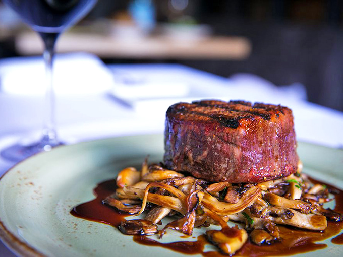 This isn't just a steak&mdash;it's a masterclass in simplicity. Perfectly seared filet mignon resting on a bed of wild mushrooms that whisper "autumn in Italy."