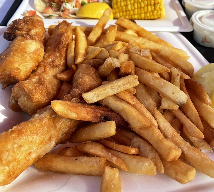 Golden-battered fish meets perfectly crisp fries in a marriage so beautiful it deserves its own reality show. The corn on the cob is just showing off.