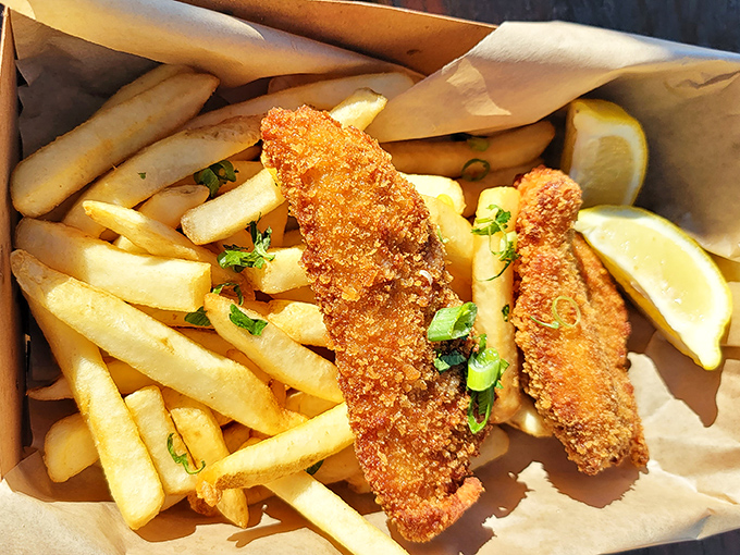 Golden-battered fish that shatters with each bite, revealing steamy, flaky perfection within. The kind of fish and chips that ruins you for all others.