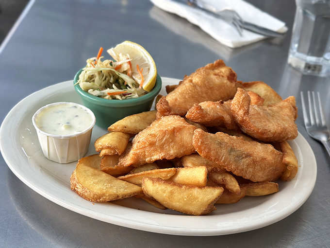 Fish and chips that actually taste like the ocean, not the fryer. The batter shatters with each bite, revealing flaky white fish that practically whispers "fresh catch."