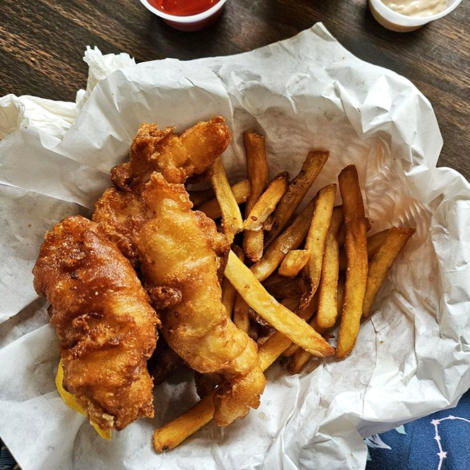 Fish and chips done right&mdash;golden batter shattering at first bite, revealing pearly white fish that was likely swimming yesterday. The fries aren't afterthoughts either.