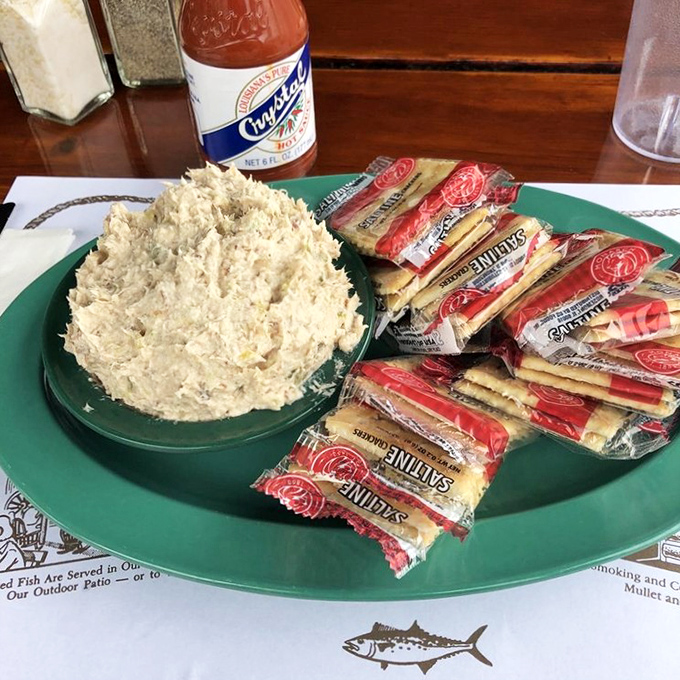The smoked fish spread arrives with a mountain of crackers, creating the perfect vehicle for this creamy, smoky masterpiece that disappears faster than Florida sunshine after a summer storm.