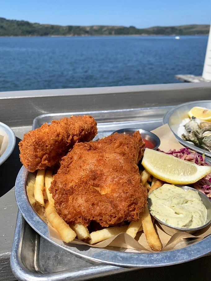 Fish and chips with a view? The crispy coating shatters with satisfying crackle while Tomales Bay provides the perfect backdrop.