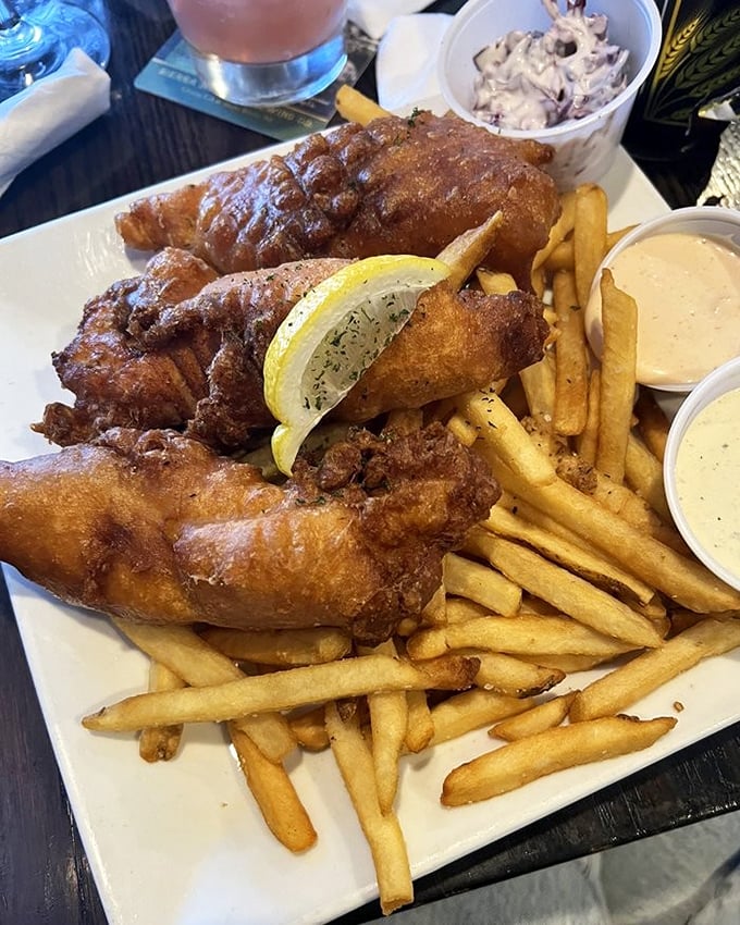 Fish and chips that would make a British pub jealous. The golden batter shatters with each bite, revealing flaky white fish beneath.