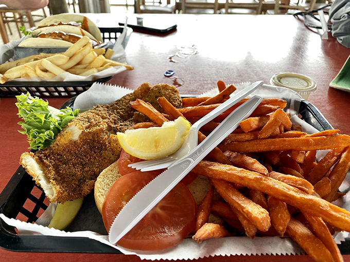 This is what vacation tastes like – a perfectly fried fish sandwich with sweet potato fries that could make a fish wish it was breaded.