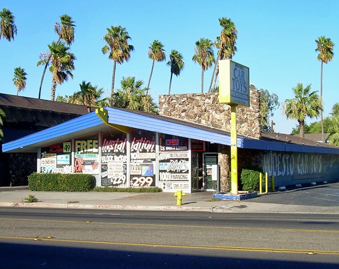 Palm trees frame this classic California roadside building, a nostalgic reminder of the era when road trips and local diners were the heart of American travel.