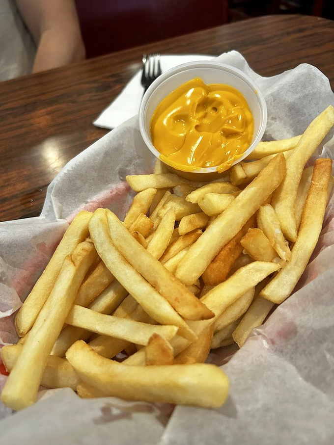 Golden fries with cheese sauce—a simple pleasure that requires no explanation, just appreciation. Crisp exterior, fluffy interior—the Aristotelian ideal of french fries.
