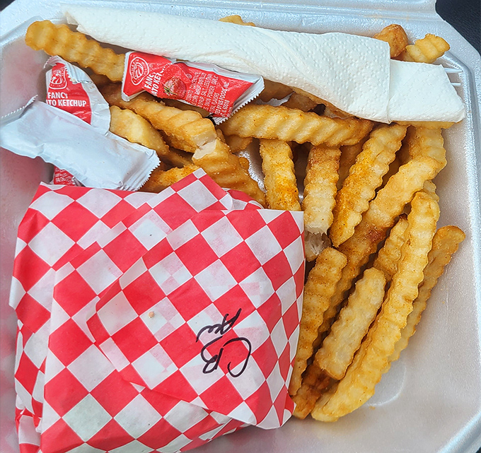 Crinkle-cut fries nestled in their red-checkered paper home. The perfect supporting actor to Johnson's burger blockbuster, crispy on the outside and fluffy within.