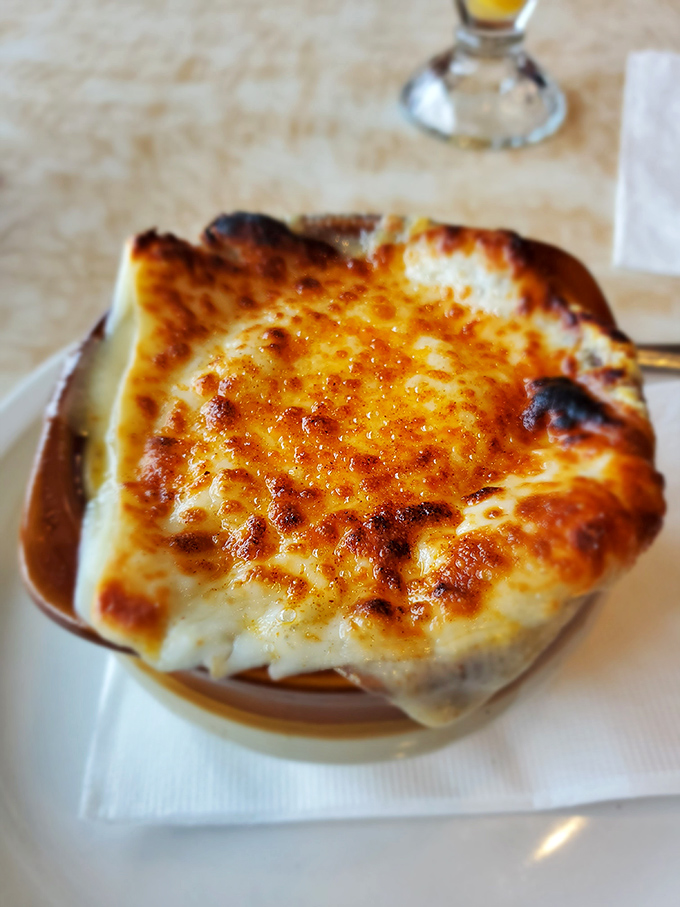 This French onion soup isn't messing around&mdash;the cheese cap is bronzed and bubbling, waiting to be broken like a cr&egrave;me br&ucirc;l&eacute;e's sugary ceiling. 