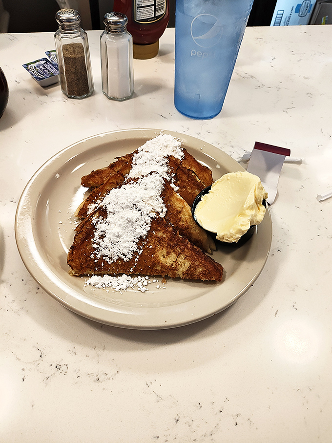French toast that's dressed for success with a snowfall of powdered sugar and a generous pat of butter. Breakfast or dessert? Yes.