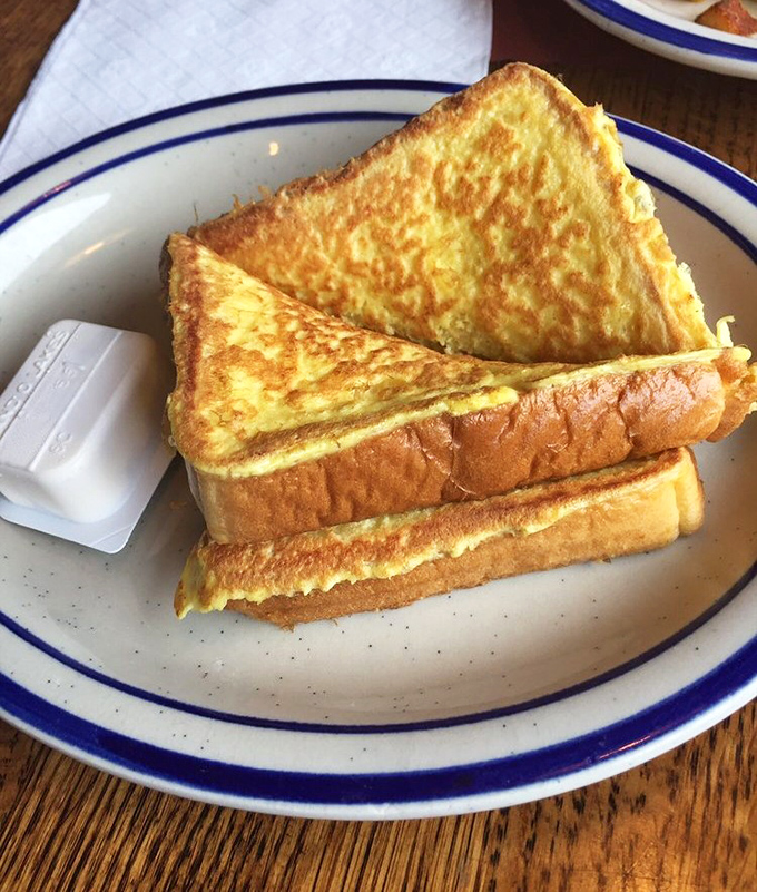 French toast so perfectly golden it belongs in Fort Knox. Simple perfection that makes you question why you'd ever eat anything else for breakfast.