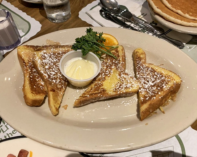 French toast that's achieved celebrity status&mdash;powdered sugar dusted like fresh snow, butter melting into those perfectly golden slices. Breakfast doesn't get more photogenic than this.