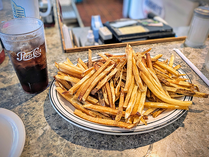 These aren't just fries—they're golden happiness sticks. Crispy outside, fluffy inside, and served alongside a Pepsi that tastes better in a diner somehow.