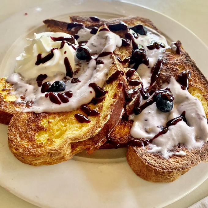 French toast that makes regular toast look like it's not even trying. Topped with cream, berries, and chocolate that should require a permission slip.