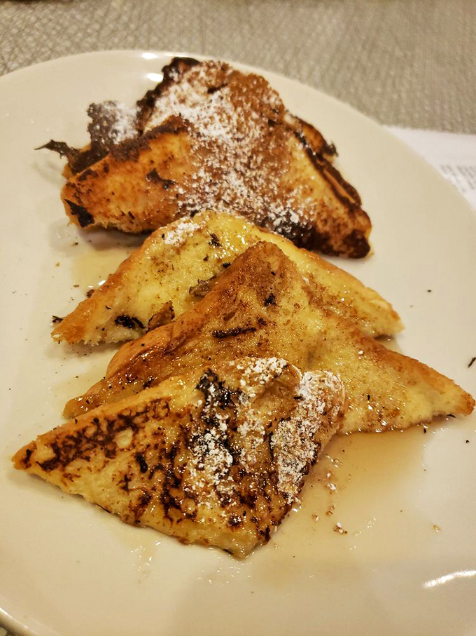 French toast that makes you question why you'd ever order anything else. That dusting of powdered sugar? Chef's kiss.