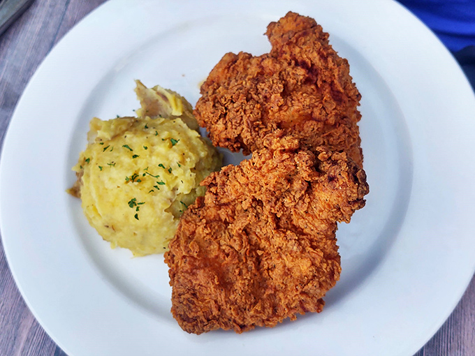 Golden-fried chicken with a crust that shatters like glass, paired with mashed potatoes that redefine comfort food.