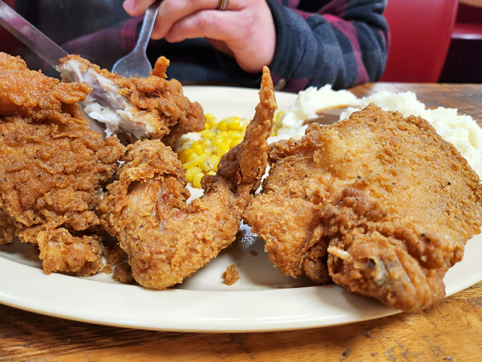 Fried chicken that would make your grandmother both proud and jealous. The kind of crispy perfection that demands you ignore your phone for a solid 20 minutes.
