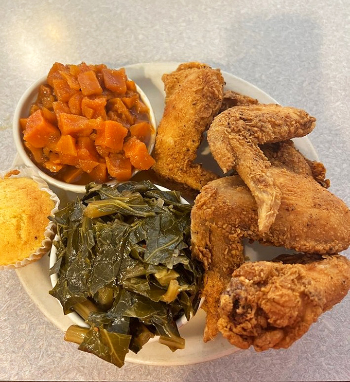 Southern comfort on a plate: crispy fried chicken, collard greens, and candied yams that would make your grandmother both proud and jealous.