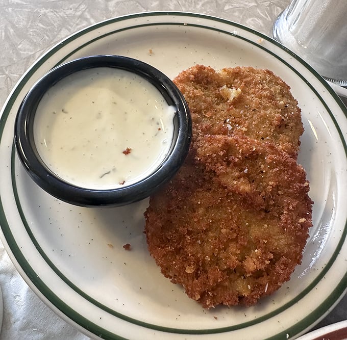 Golden-fried perfection meets creamy dipping sauce. This fried green tomato isn't just a side&mdash;it's the main event.