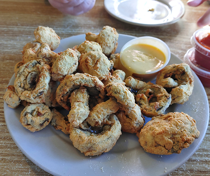 These golden-fried mushrooms aren't just appetizers &ndash; they're crispy preludes to seafood glory, with that perfect crunch-to-tender ratio that makes you forget vegetables were involved.