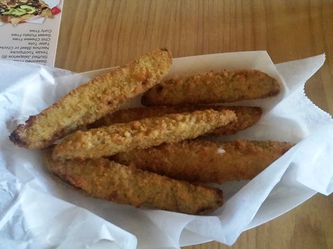 These aren't your average fried pickles. Golden-brown, crispy exterior giving way to that tangy, briny goodness inside. Addiction in a basket.