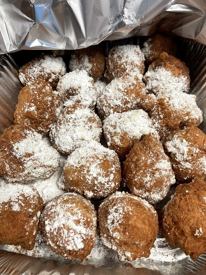 These powdered sugar-dusted fritters aren't trying to reinvent the wheel&mdash;they're just making it deliciously round, sweet, and impossible to eat without a smile.