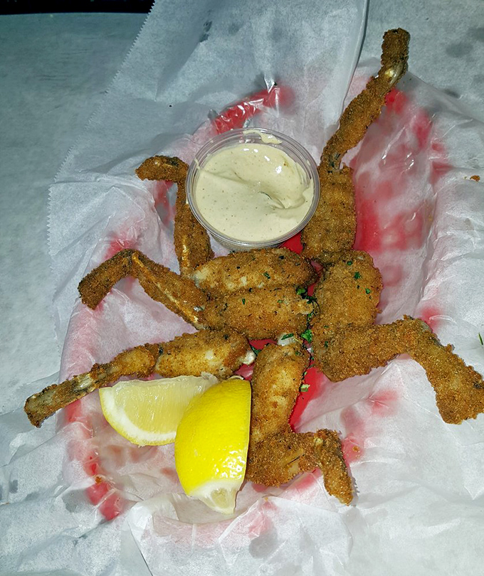 Golden-fried frog legs – the unsung heroes of the menu. Crispy, tender, and served with a dipping sauce that would make a cardboard box taste good.
