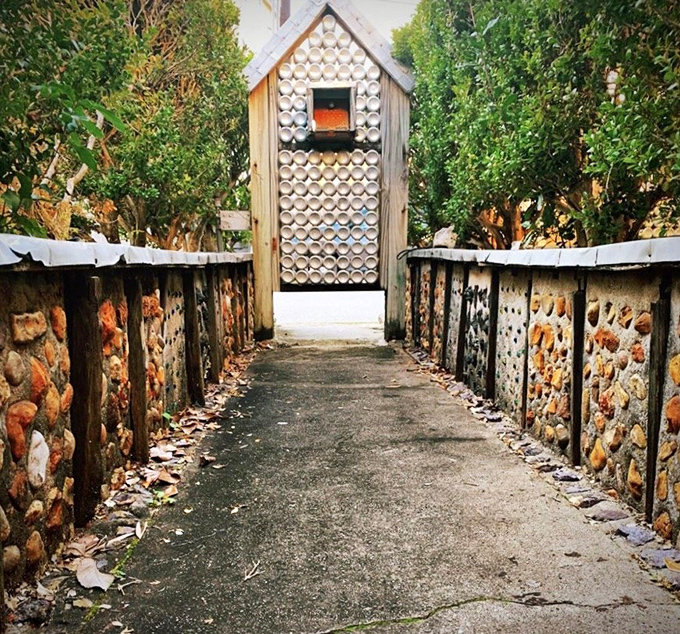 The entryway feels like stepping through a portal to Wonderland, if Alice had developed a taste for Budweiser instead of tea.