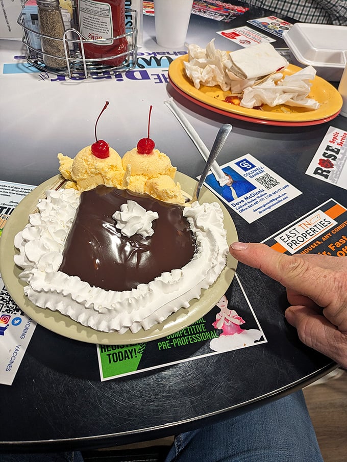 The legendary fudge cake that launches road trips, topped with vanilla ice cream and cherries. Resistance is futile, diets are postponed.