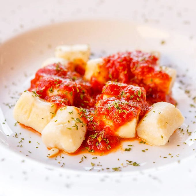 These pillowy gnocchi swimming in marinara are like little clouds that decided to vacation in tomato heaven. Each bite is a tiny miracle.