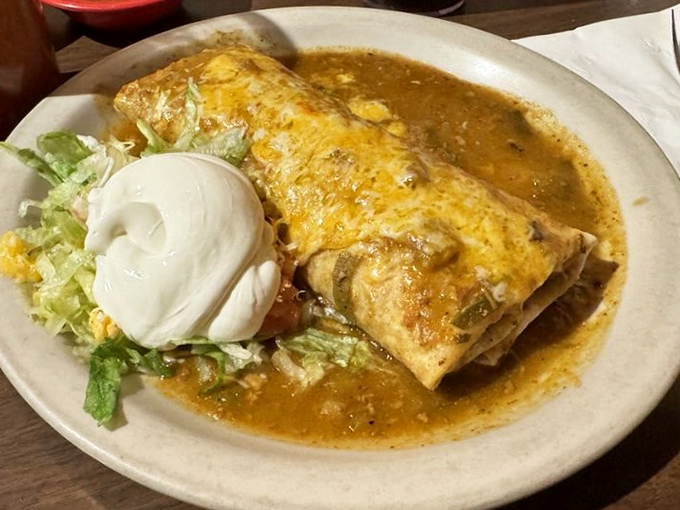 The Gollo Burro arrives swimming in that famous green chili sauce, proving sometimes the messiest dishes are the most memorable.