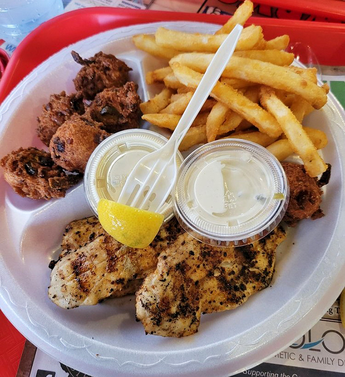 Perfectly blackened fish with a squeeze of lemon&mdash;proof that simplicity, when executed flawlessly, creates the most memorable meals. Those hushpuppies deserve their own fan club.