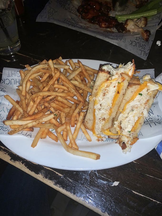 The legendary grilled cheese in its golden-brown glory, flanked by perfectly crisp fries. This sandwich doesn't just speak to your soul &ndash; it sings a full aria.