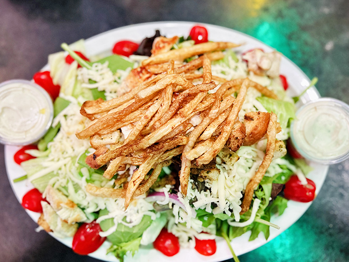 When a salad looks this good, even carnivores might pause&mdash;crispy fries crowning fresh greens in a delicious role reversal.