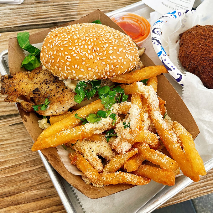 The legendary grouper sandwich in its full glory&mdash;a perfect architecture of crispy, flaky, and fresh. Those parmesan fries aren't just a side; they're co-stars.