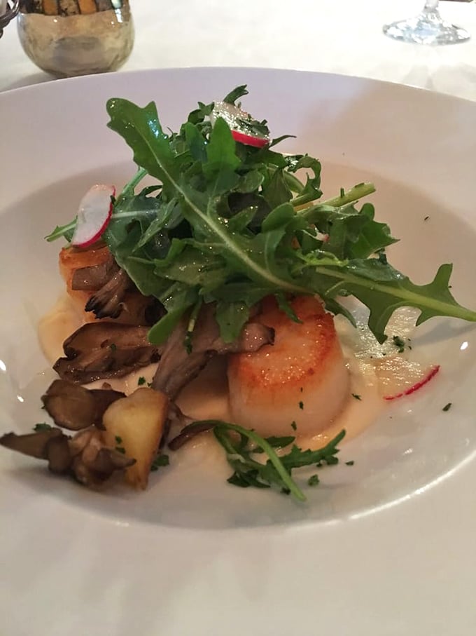 This scallop isn't just cooked &ndash; it's been sweet-talked to perfection, then dressed with mushrooms and greens for a first date with your taste buds.