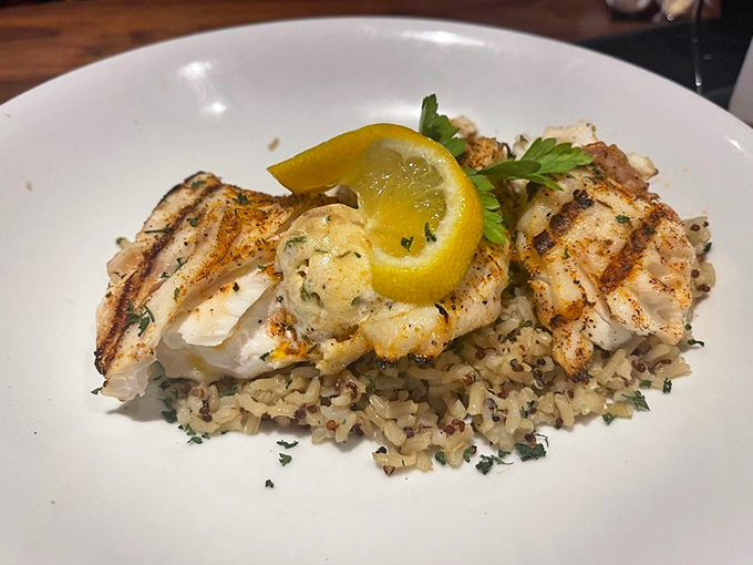 Perfectly grilled fish atop a bed of rice that didn't just phone it in. That lemon wedge isn't decoration&mdash;it's the finishing touch on a masterpiece.